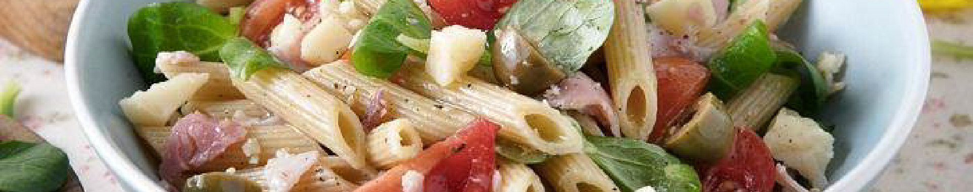 Cold pasta salad with cherry tomatoes, green olives, ham, lamb’s ...